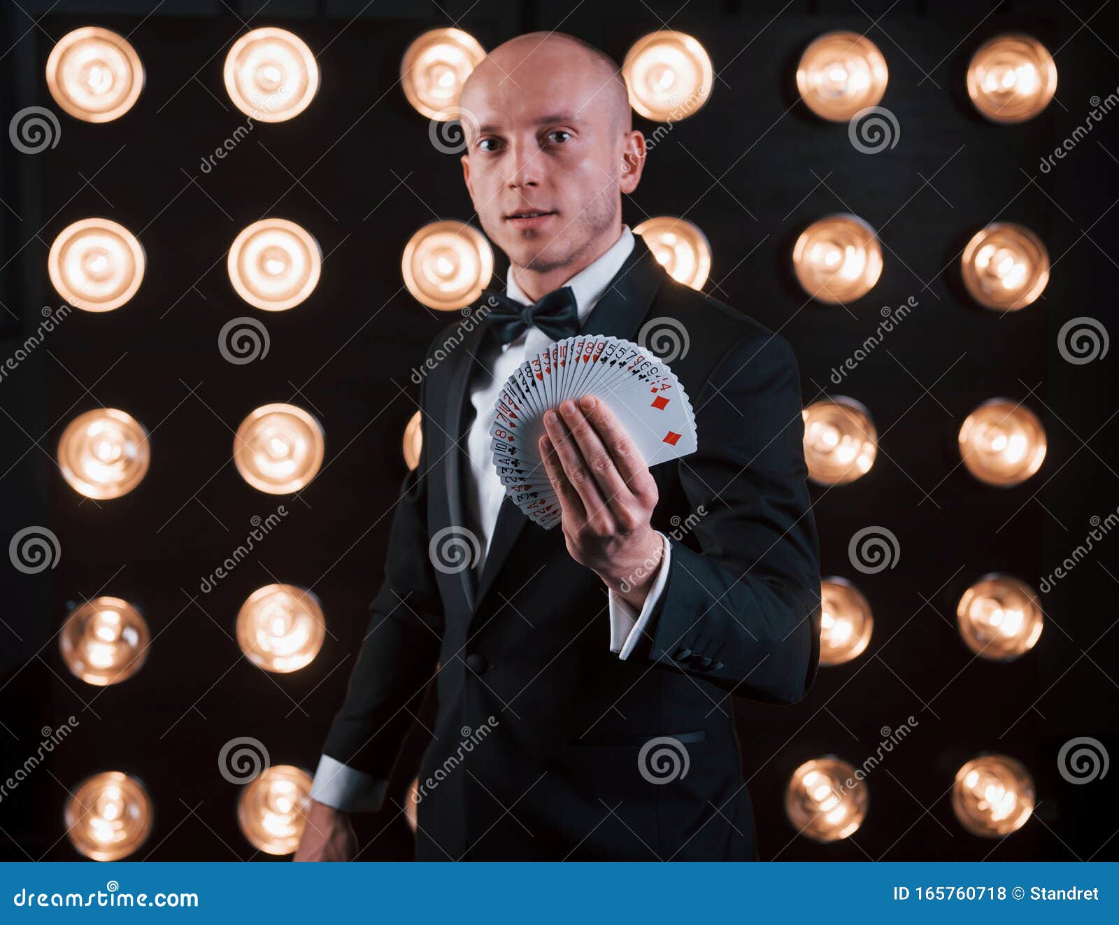 On the Work. Magician in Black Suit Standing in the Room with Special ...