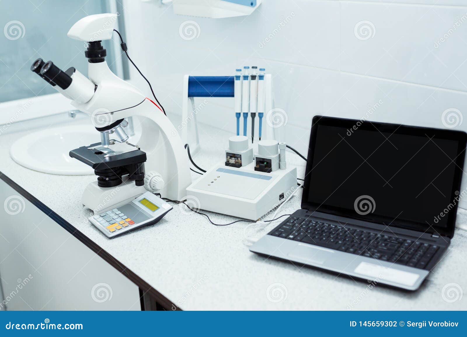 Work Place of Laboratory Worker. Notebook and Microscope Adjusted and ...