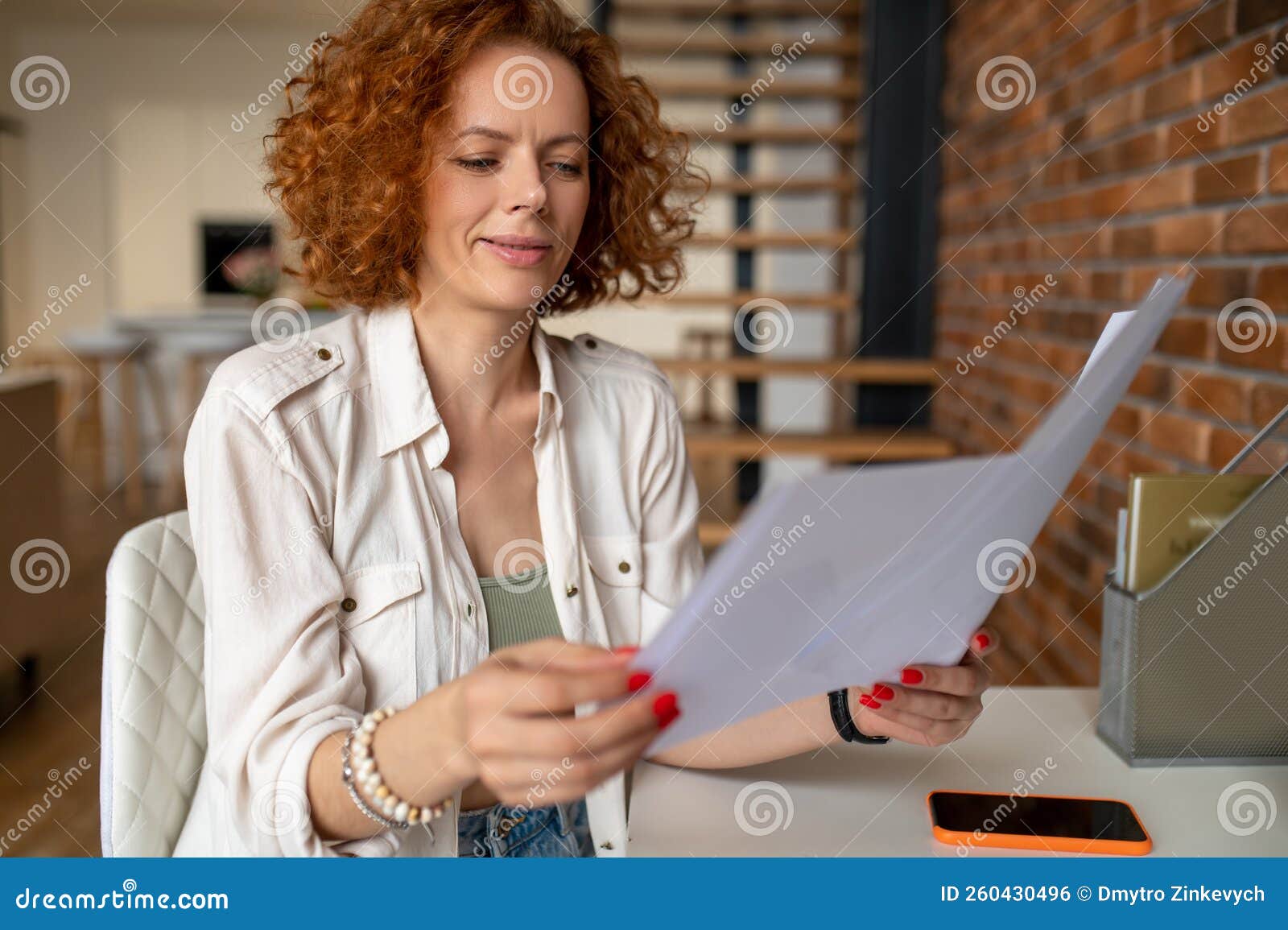Female Manager Scrutinizing Papers and Looking Involved Stock Photo ...