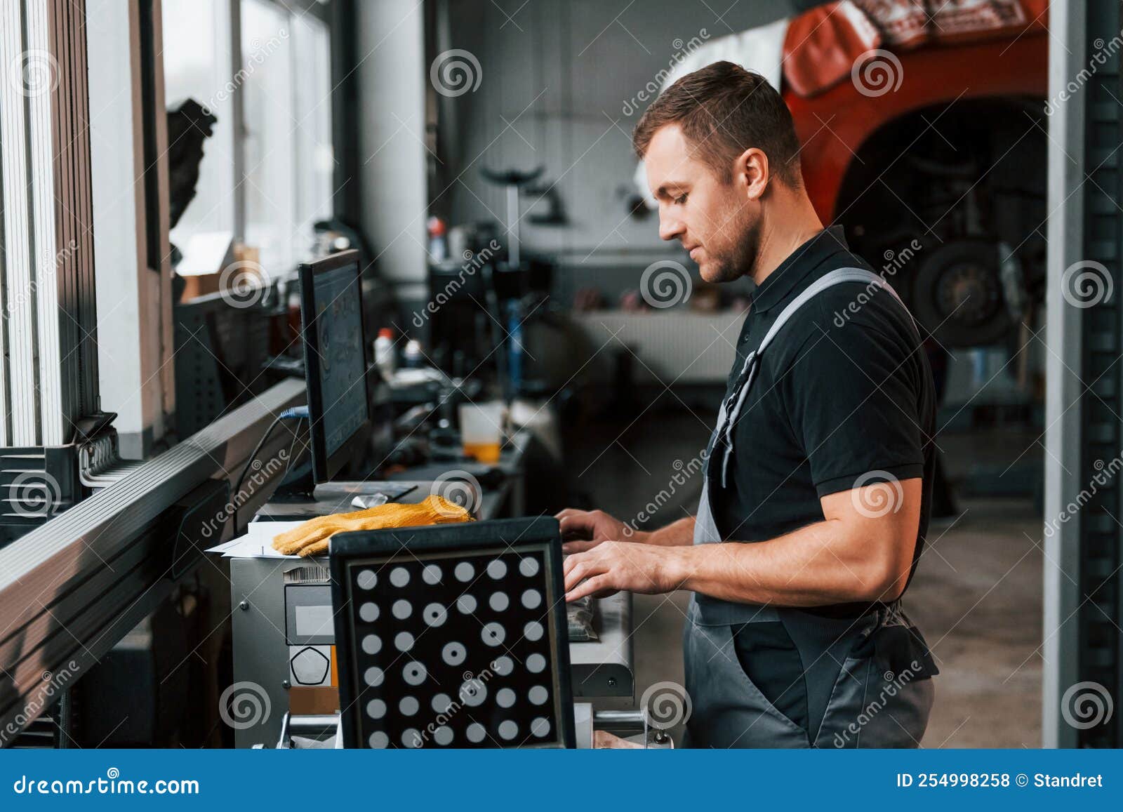 Work in Progress. Man in Uniform is in the Auto Service Stock Photo ...