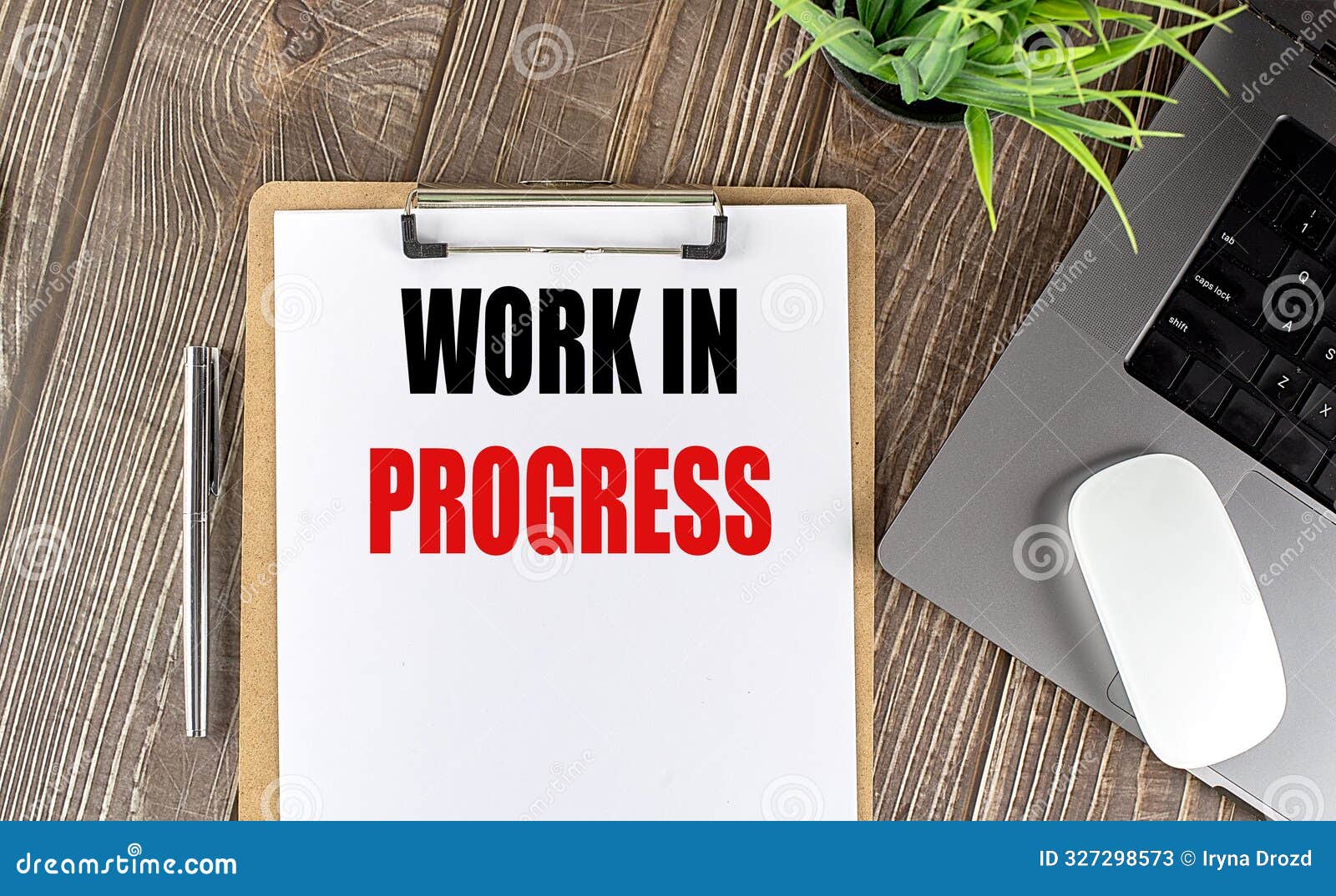 WORK in PROGRESS Text on Clipboard Paper with Laptop, Mouse and Pen ...