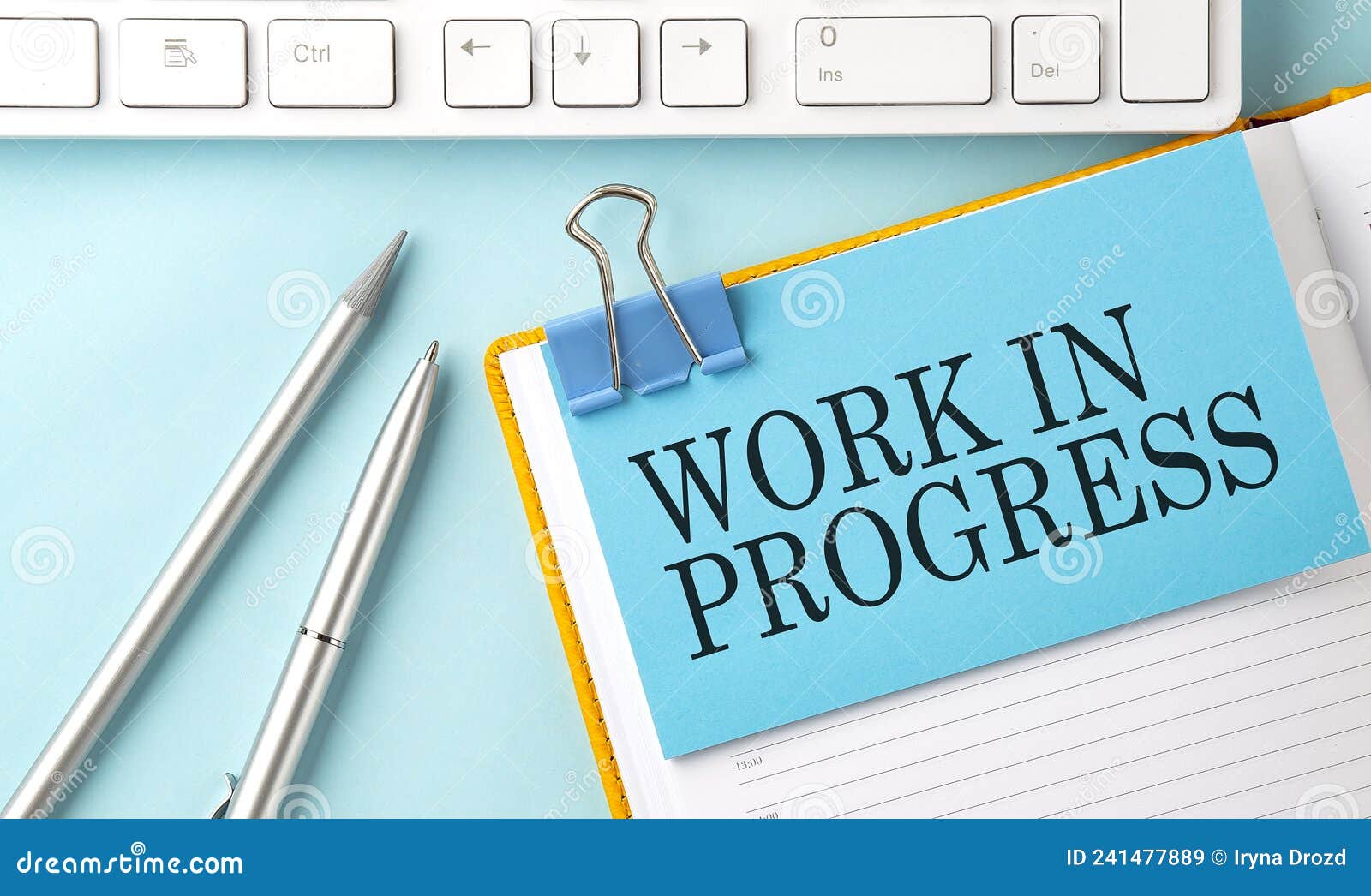 WORK in PROGRESS Text on Sticker on the Blue Background with Pen and ...