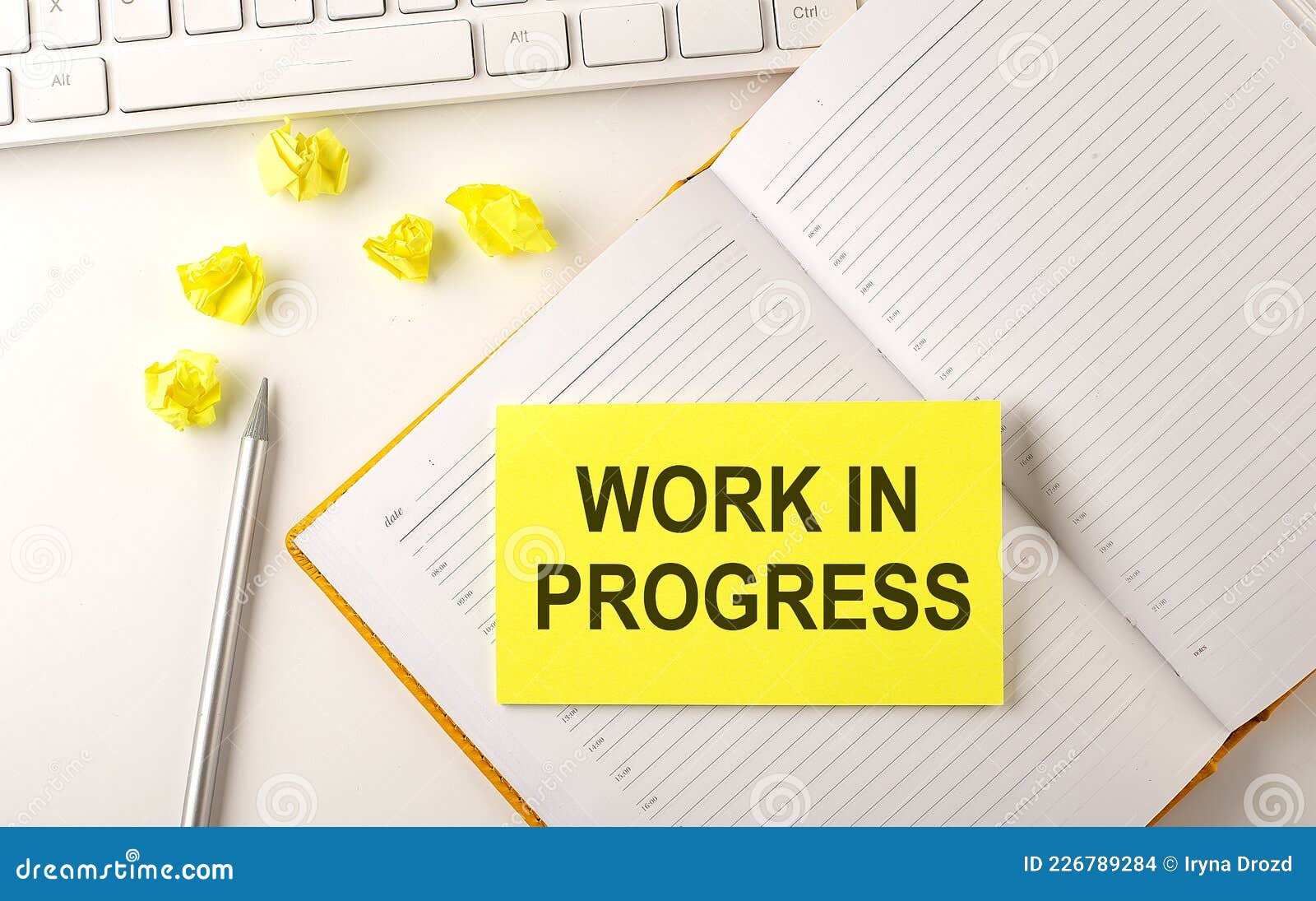 WORK in PROGRESS Text on Sticker on the Diary with Keyboard and Pencil ...