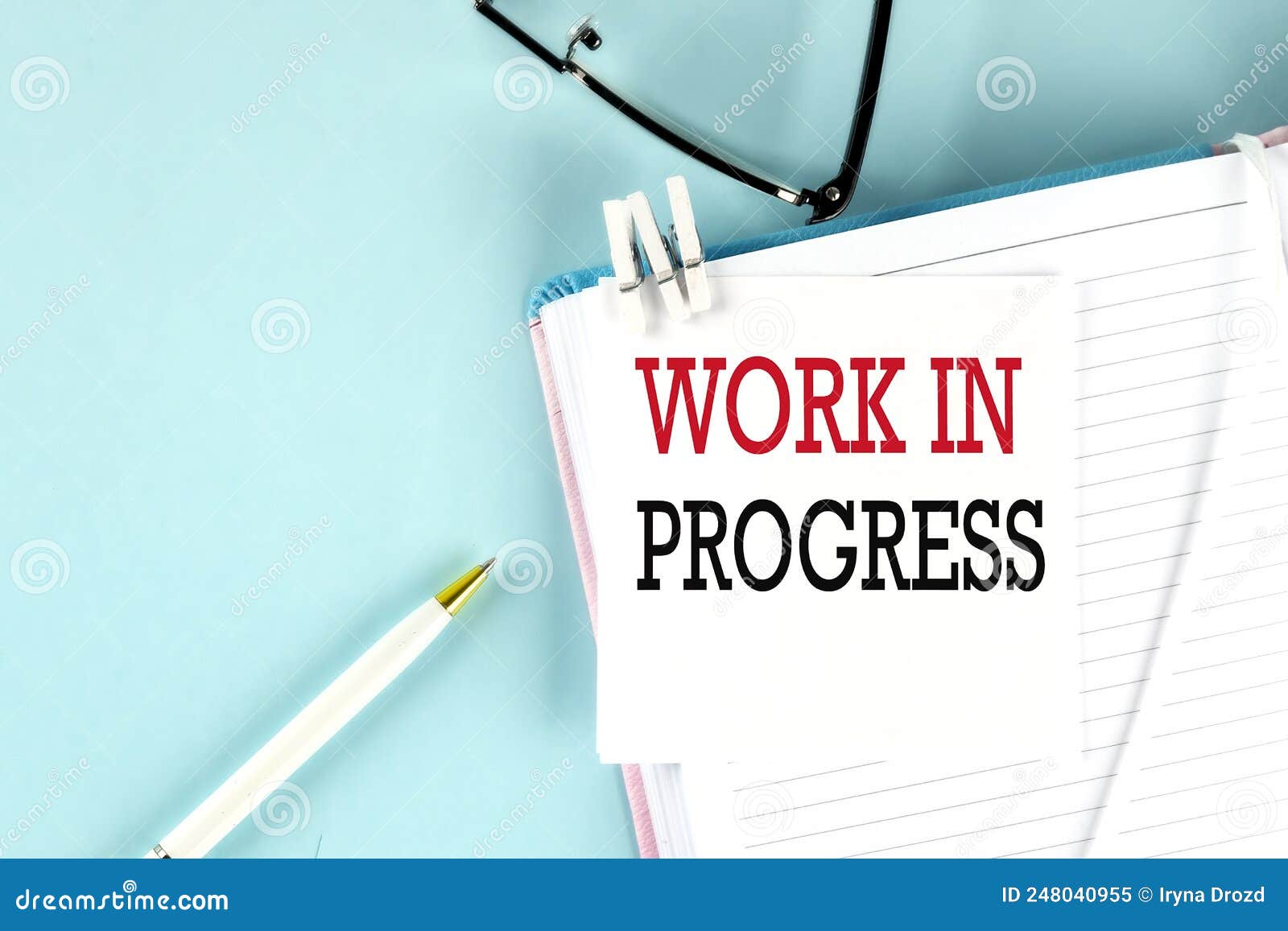 WORK in PROGRESS Text on a Sticky on Notebook with Pen and Glasses ...