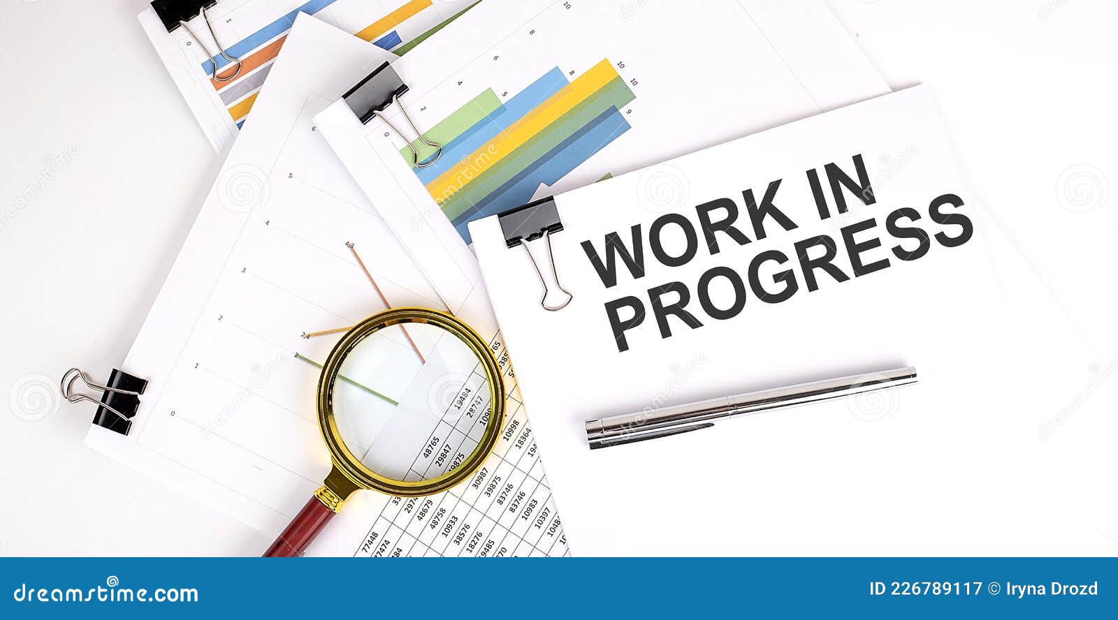 WORK in PROGRESS Text on White Paper on Light Background with Charts ...