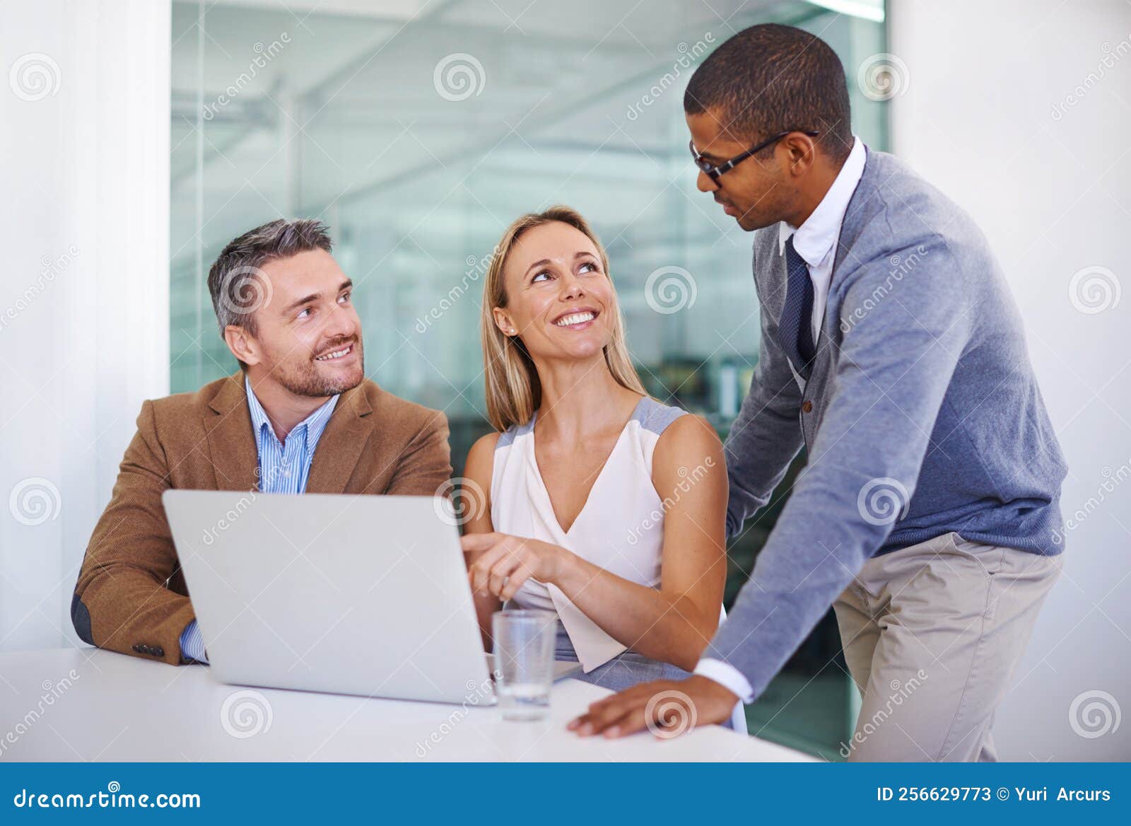 We Work Well Together. Three Colleagues Working Together at a Laptop ...
