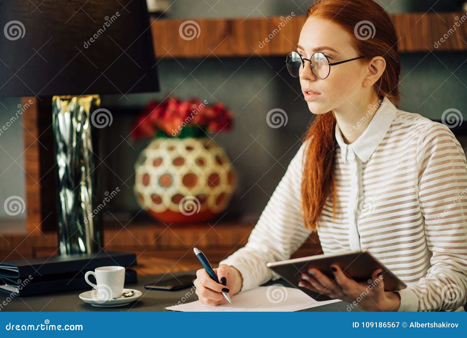 Woman Writing on Paper with Digital Tablet Computer in Office Room ...