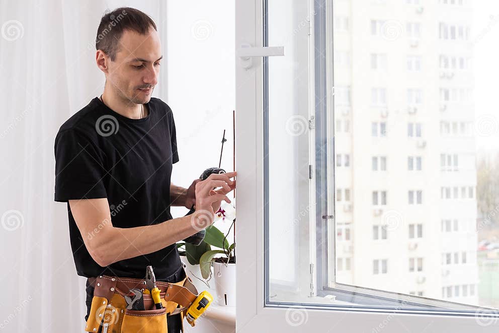 Worker Adjusting Installed Window with Screwdriver Indoors, Closeup ...
