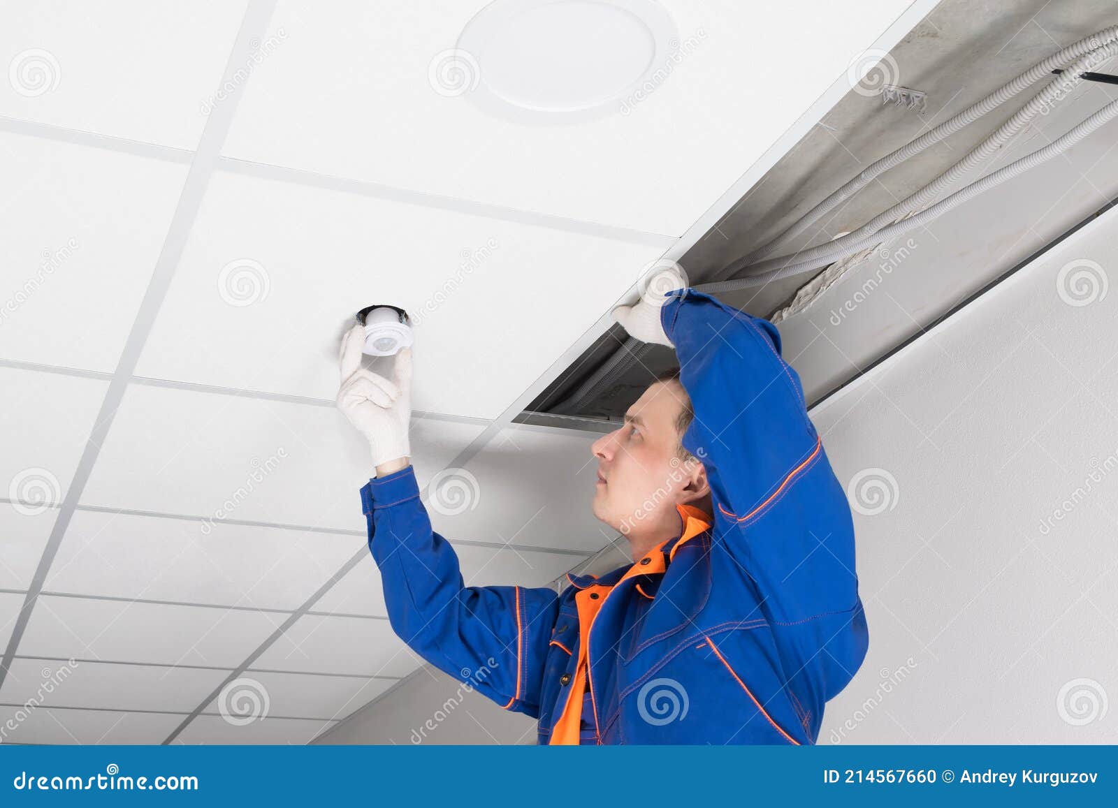 A Worker Adjusts the Luminaire in the False Ceiling Stock Photo - Image ...
