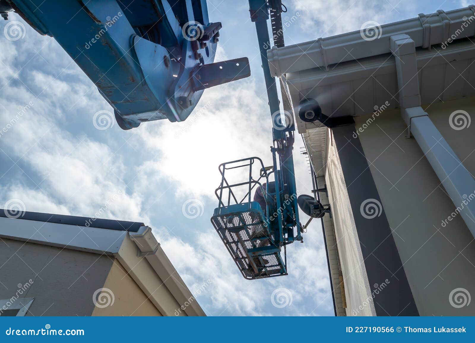 Worker On An Aerial Platform With Their Reflection On The Glass Facade ...