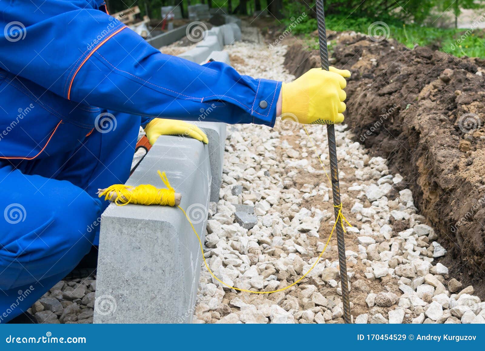 Worker Aligns Curbstone with Yellow Rope Stock Image - Image of copy ...