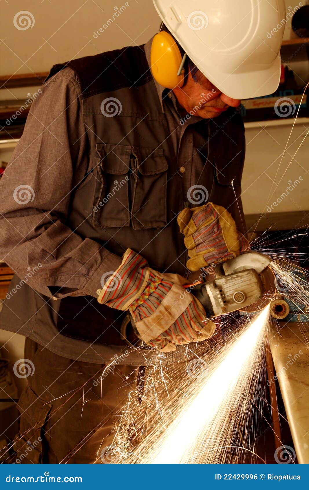 Worker with angle grinder stock photo. Image of industry - 22429996
