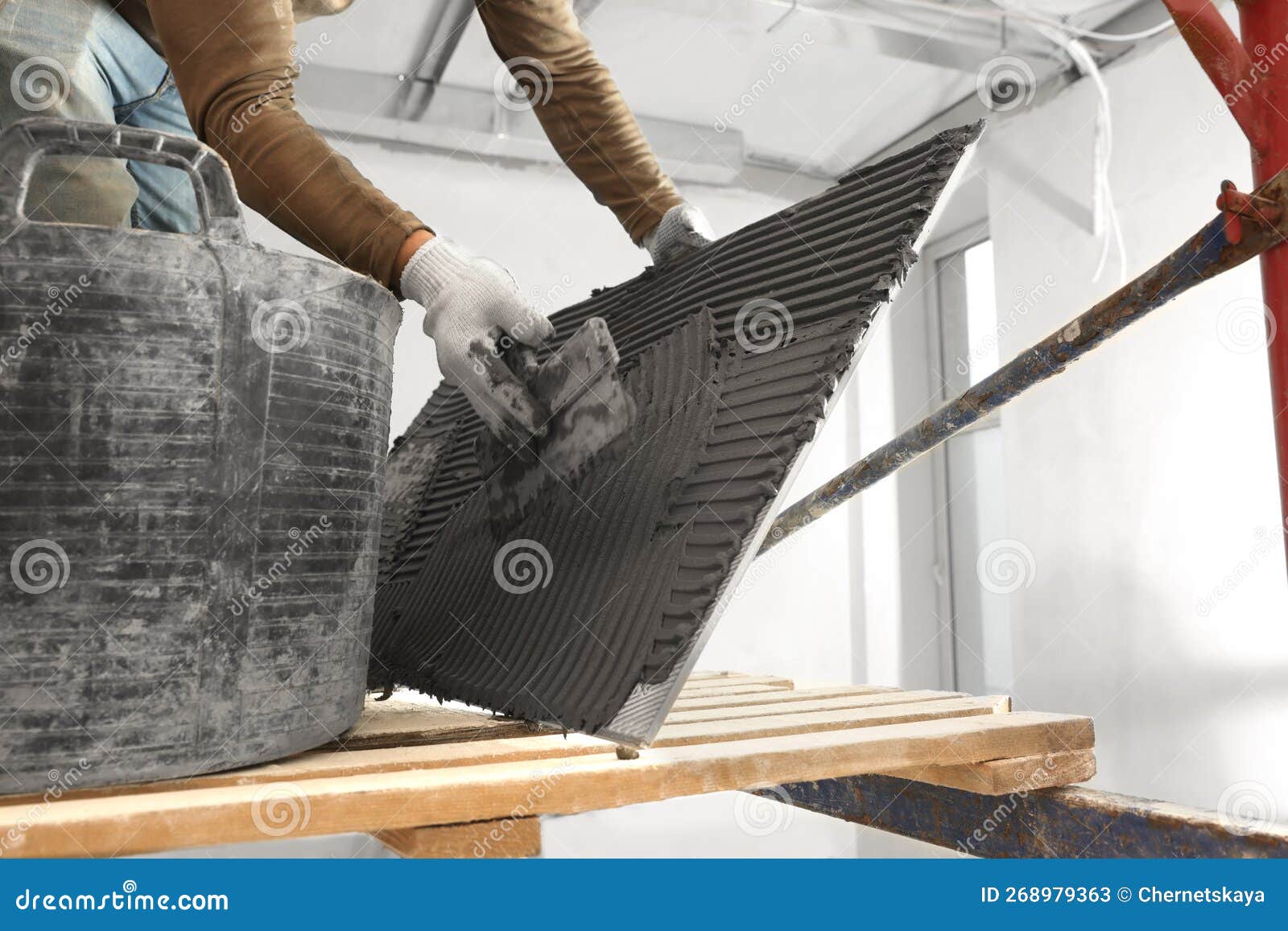 Worker Applying Cement on Tile for Installation in Room, Closeup Stock ...