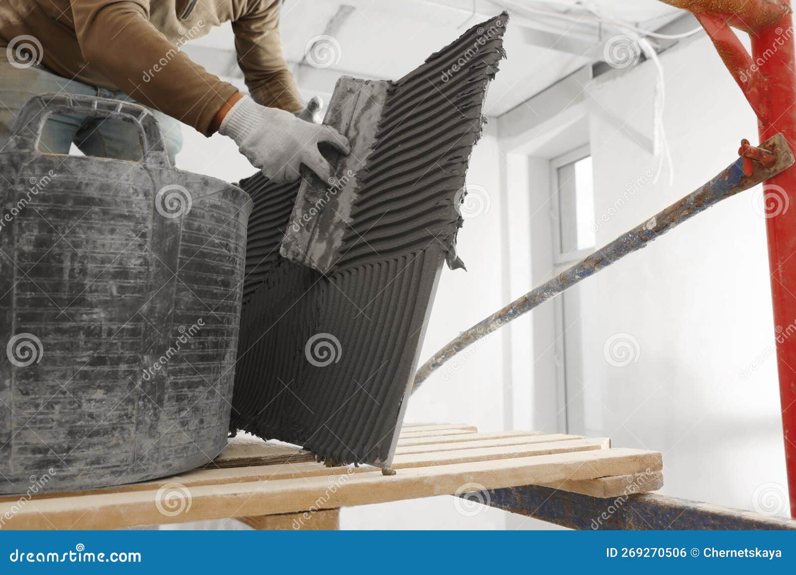 Worker Applying Cement on Tile for Installation in Room, Closeup Stock ...