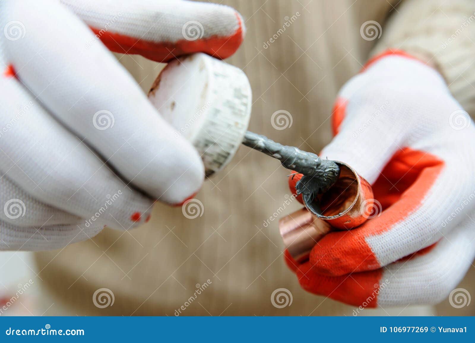 A worker is applying flux. stock image. Image of house - 106977269