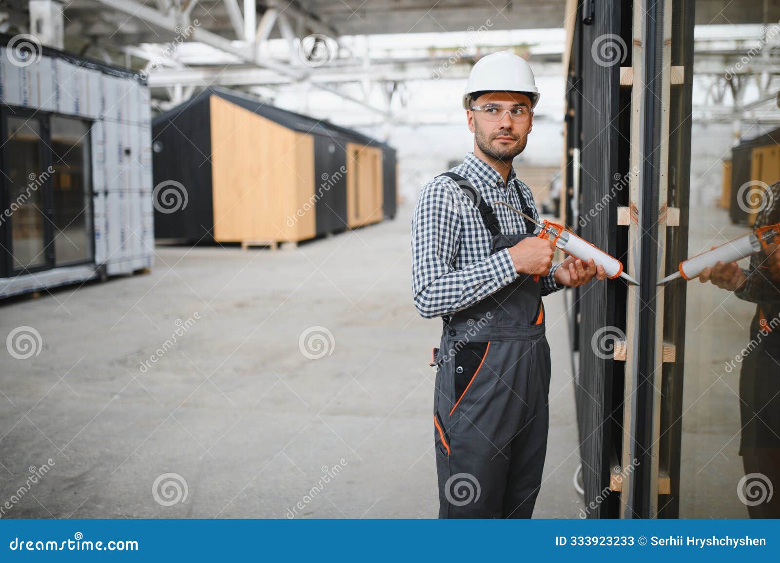 A Worker is Applying Polyurethane Foam To Fill Gap between Sash and ...