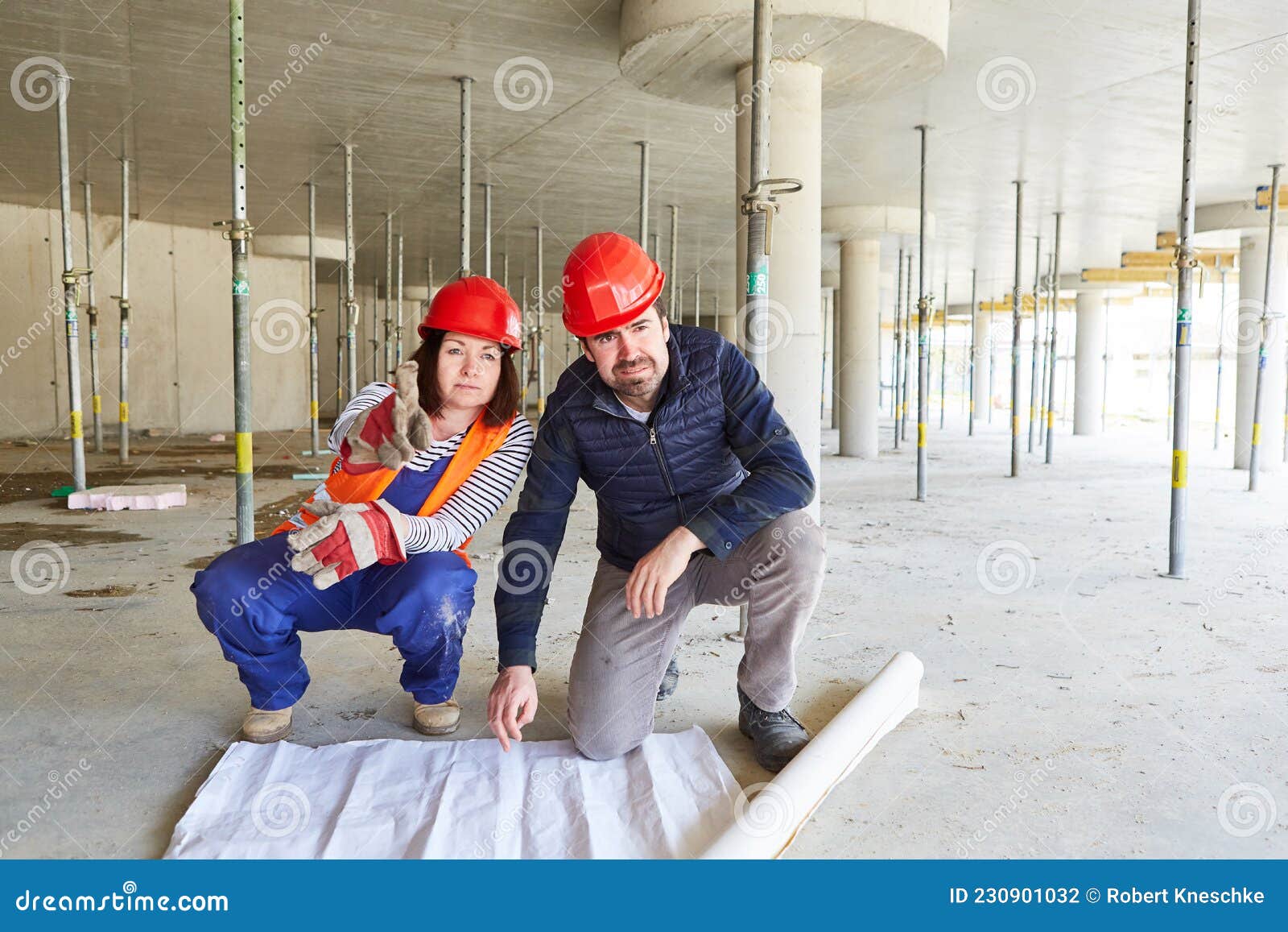 Worker and Architect with Floor Plan on a Construction Site Stock Photo ...
