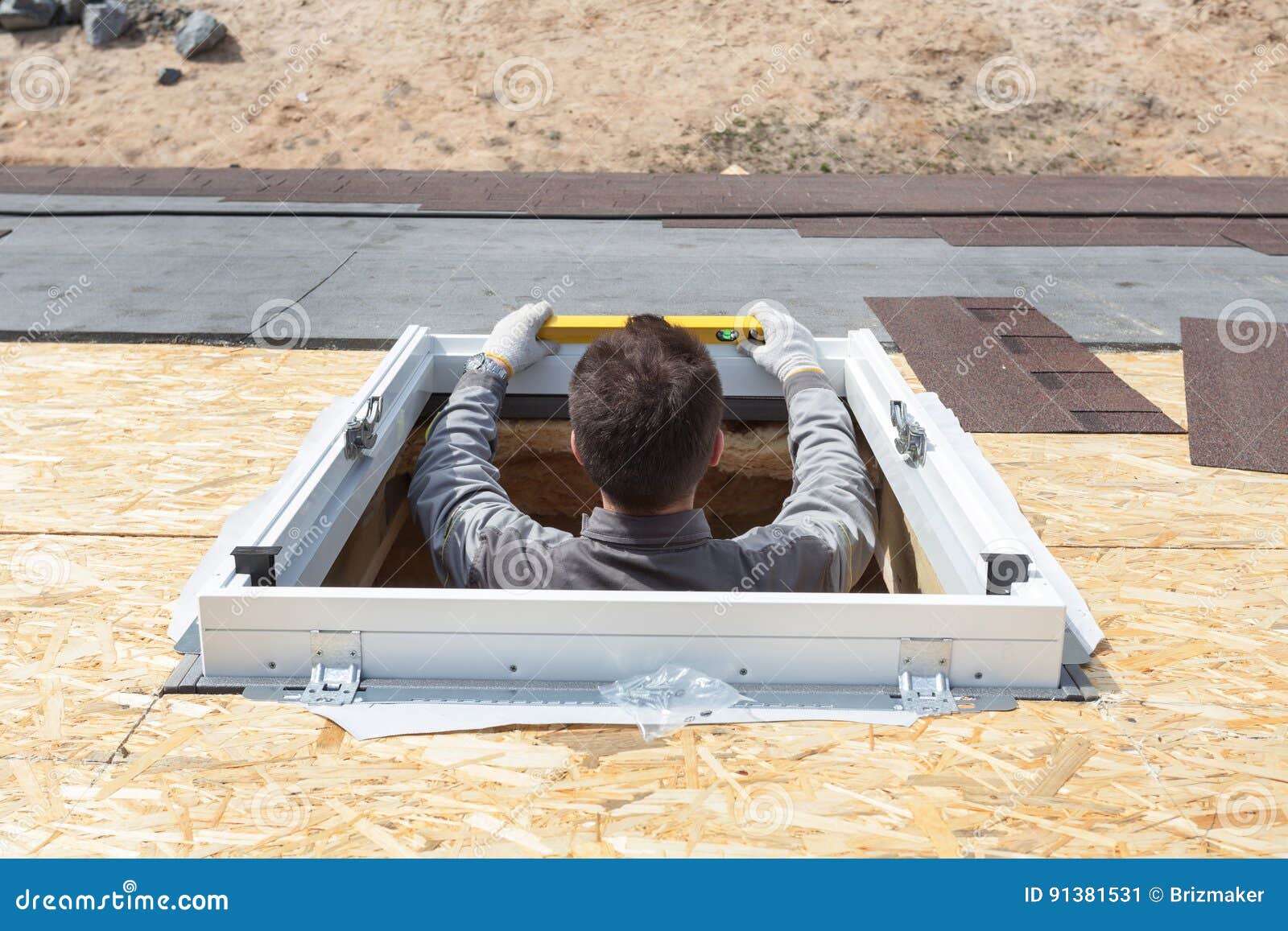 Worker on a Asphalt Shingle Roof Installing New Plastic Mansard or ...