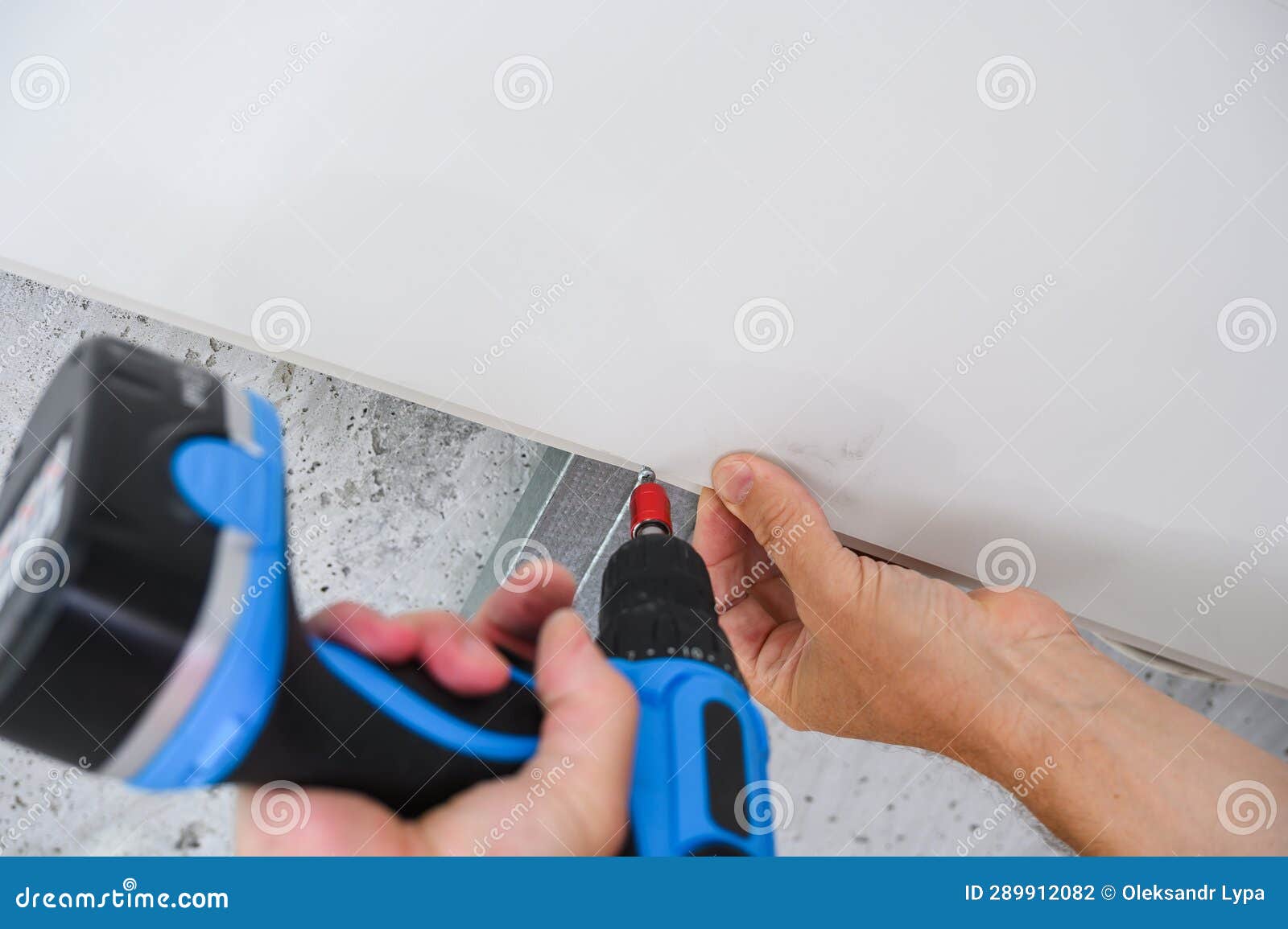 Worker Assemble a Suspended Ceiling and Fixing Panel with an ...