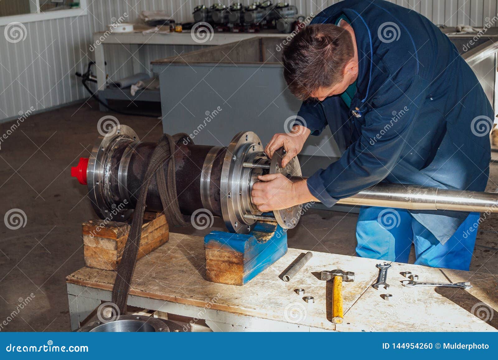 Worker Assembles Machine Part in a Factory Editorial Image - Image of ...