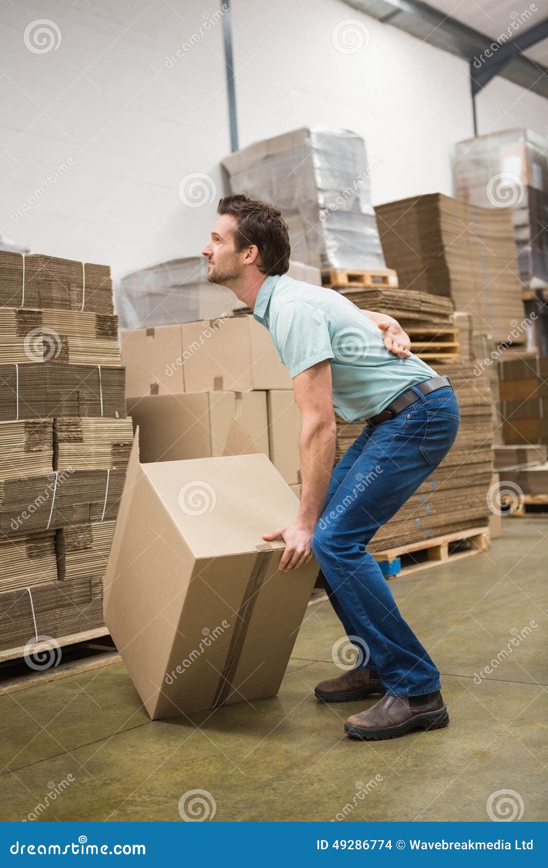 Worker with Backache while Lifting Box in Warehouse Stock Photo - Image ...