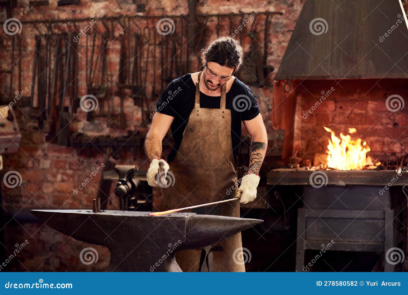 Worker, Blacksmith and Metal Forge in Workshop and Manual Working on Hot Steel with Hammer, Fire ...
