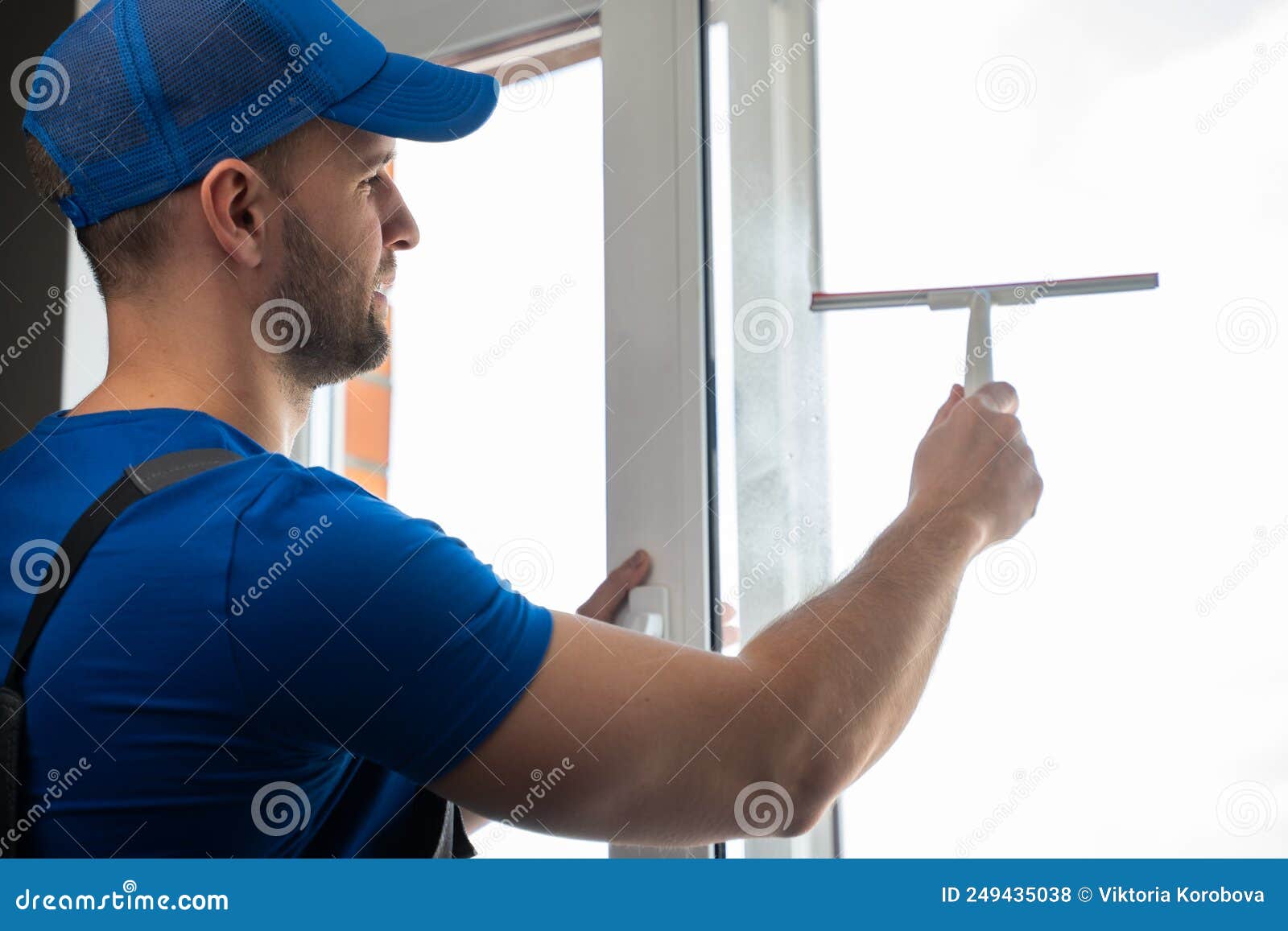 Man Cleans Plastic Window Glass with Detergent and Squeegee Stock Photo ...