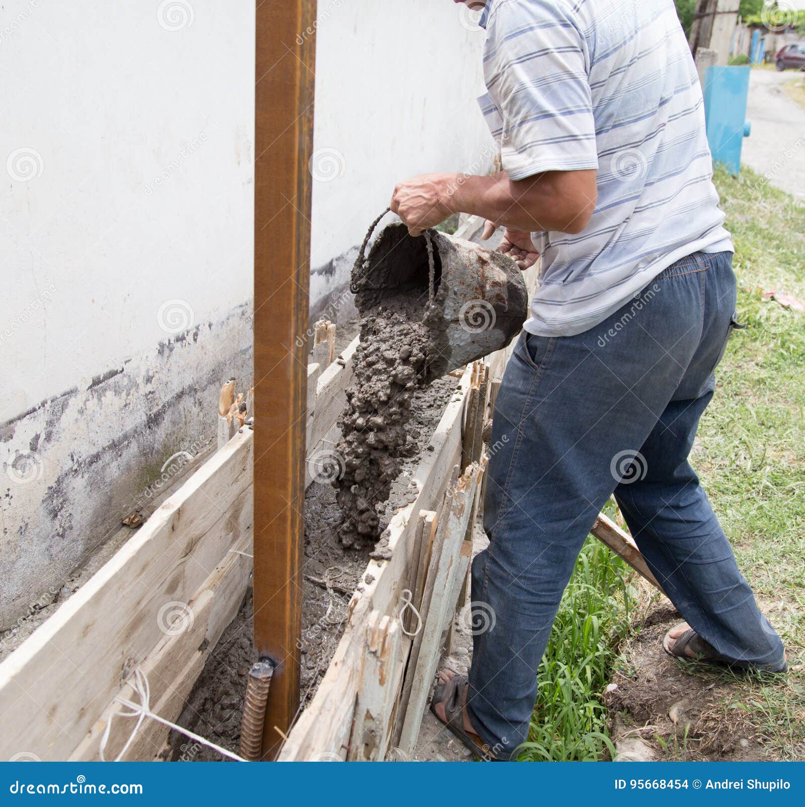Worker with a Bucket of Concrete on a Construction Site Stock Photo ...