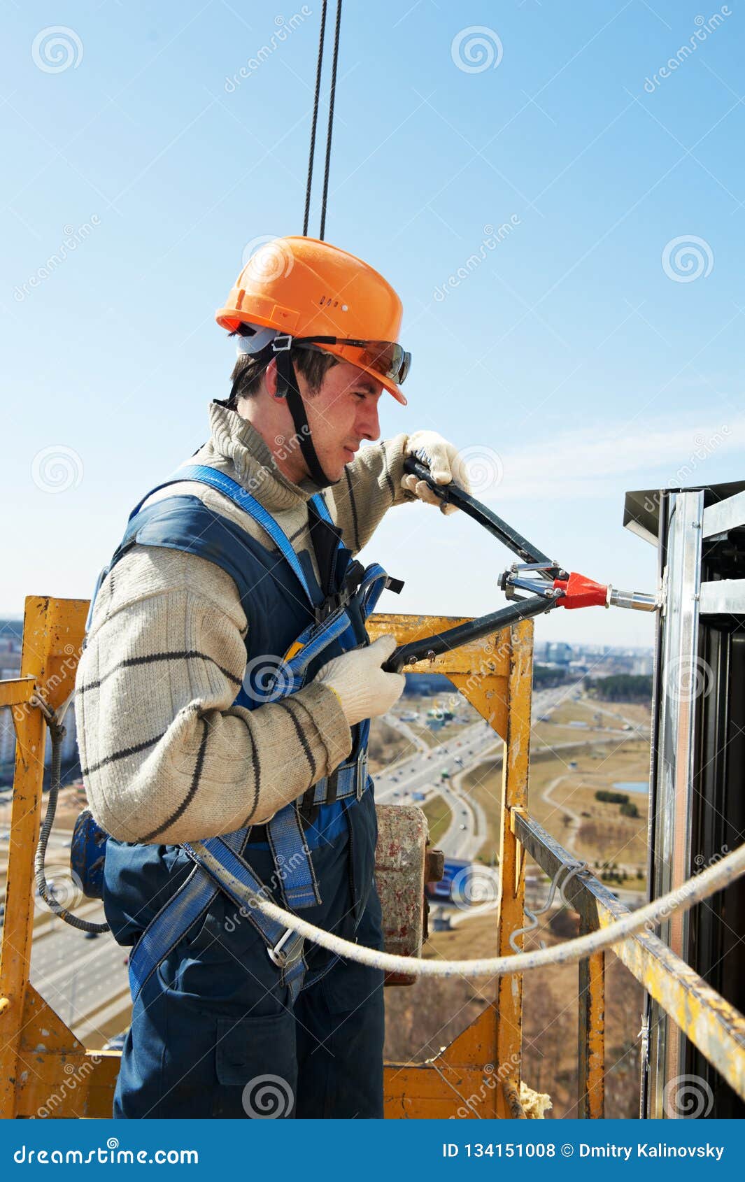 Worker Builder at Facade Installation Work with Riveting Hammer Stock ...