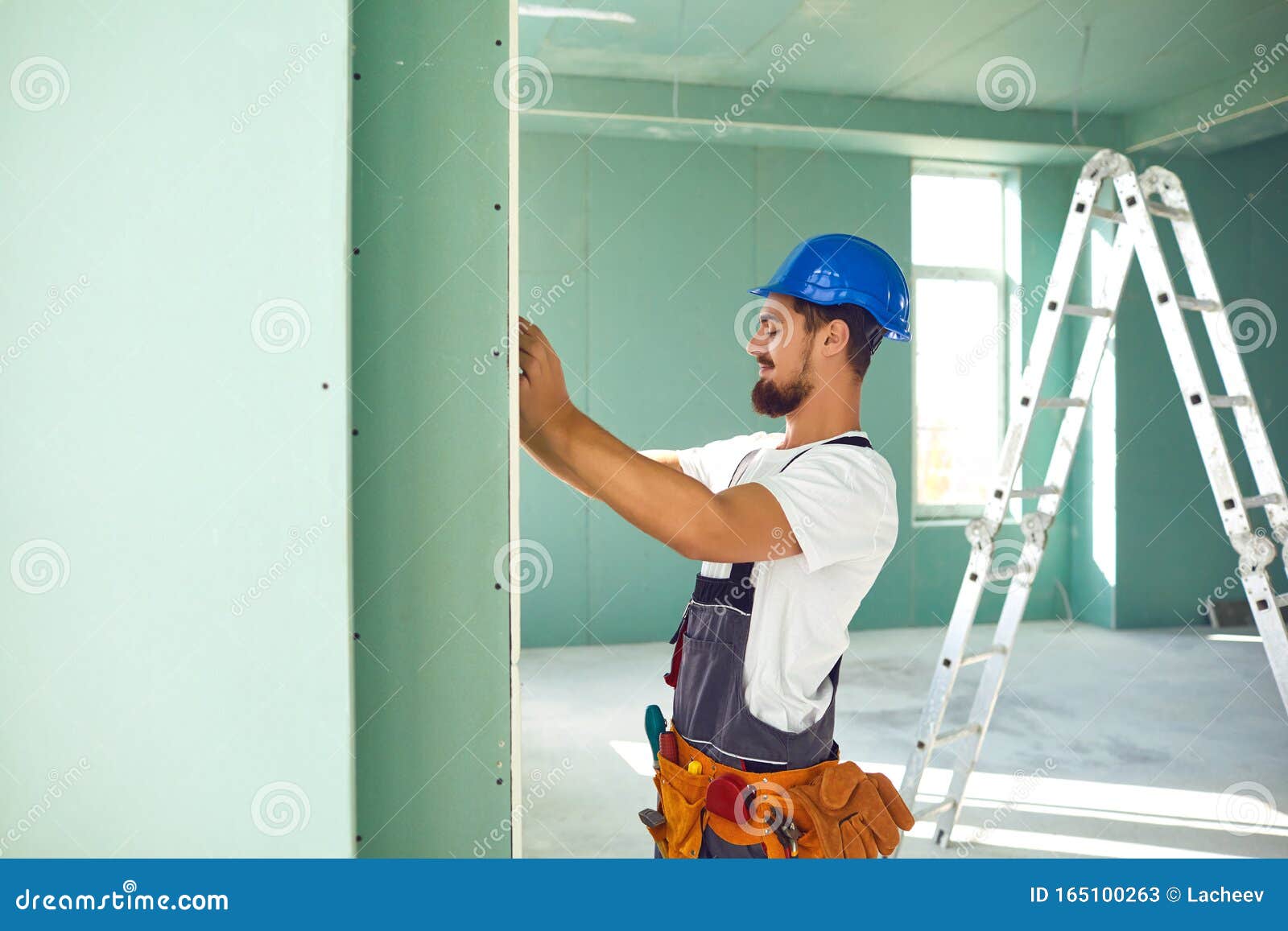 Worker Builder Installs Plasterboard Drywall at a Construction Stock ...