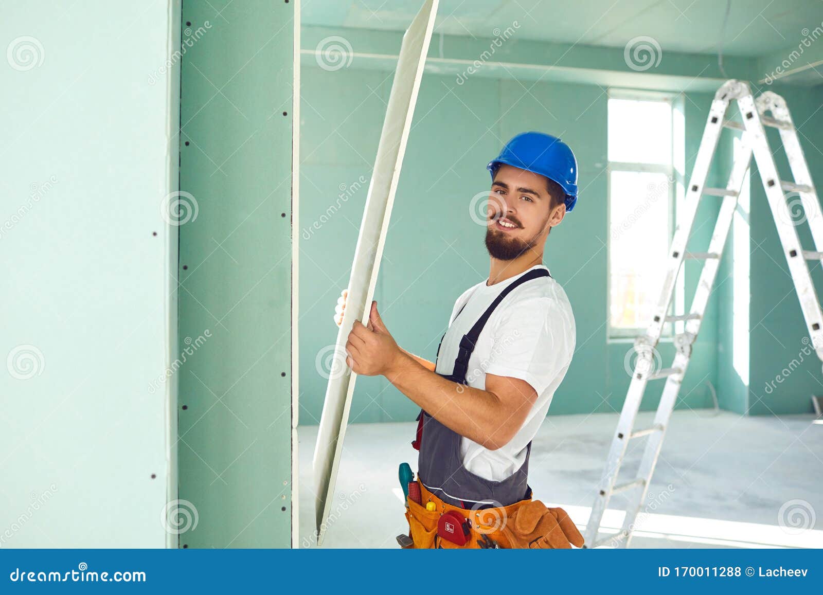 Worker Builder Installs Plasterboard Drywall at a Construction Stock ... Worker Builder Installs Plasterboard Drywall at a Construction Stock ...