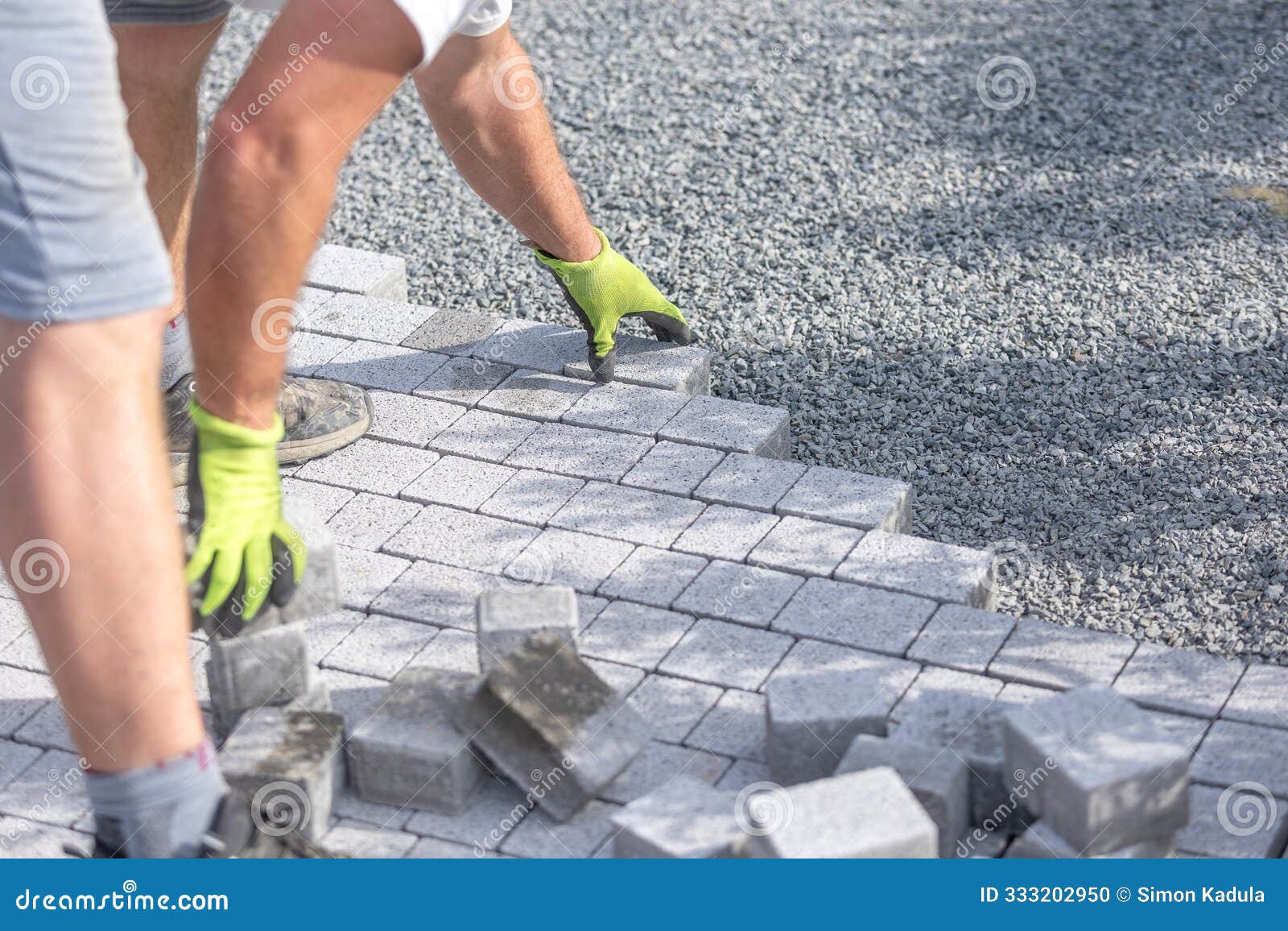 Worker Building a New Interlocking Pavement from Concrete Paving, a New ...