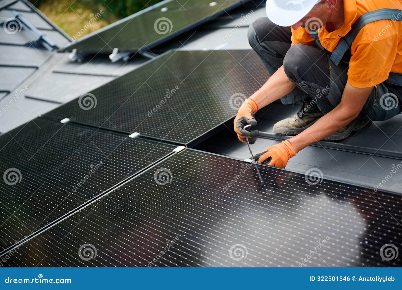 Worker Building Photovoltaic Solar Panel System on Rooftop of House ...
