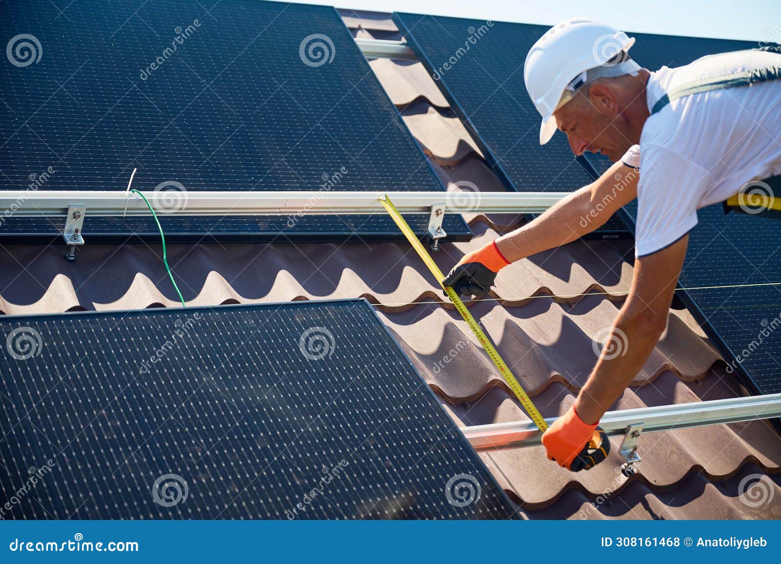 Worker Building Photovoltaic Solar Panel System, Using Ruler To Measure ...