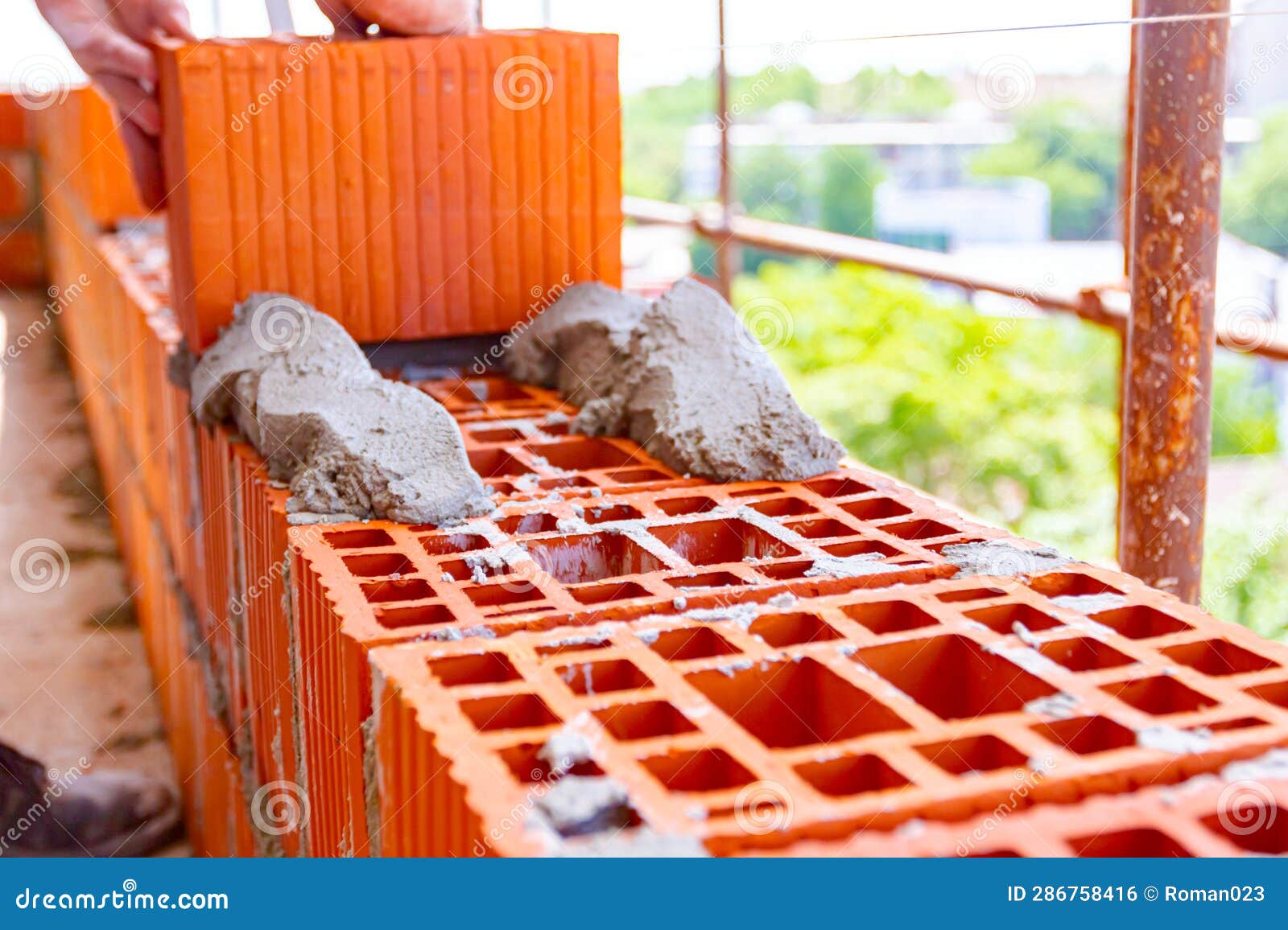Worker is Building Wall with Red Blocks and Mortar Stock Photo - Image ...