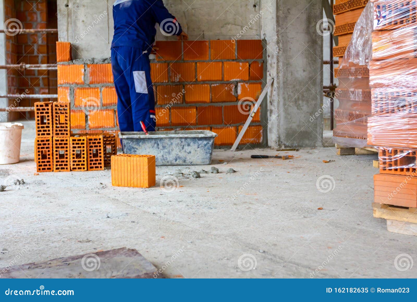 Worker is Building Wall with Red Blocks and Mortar Stock Image - Image ...