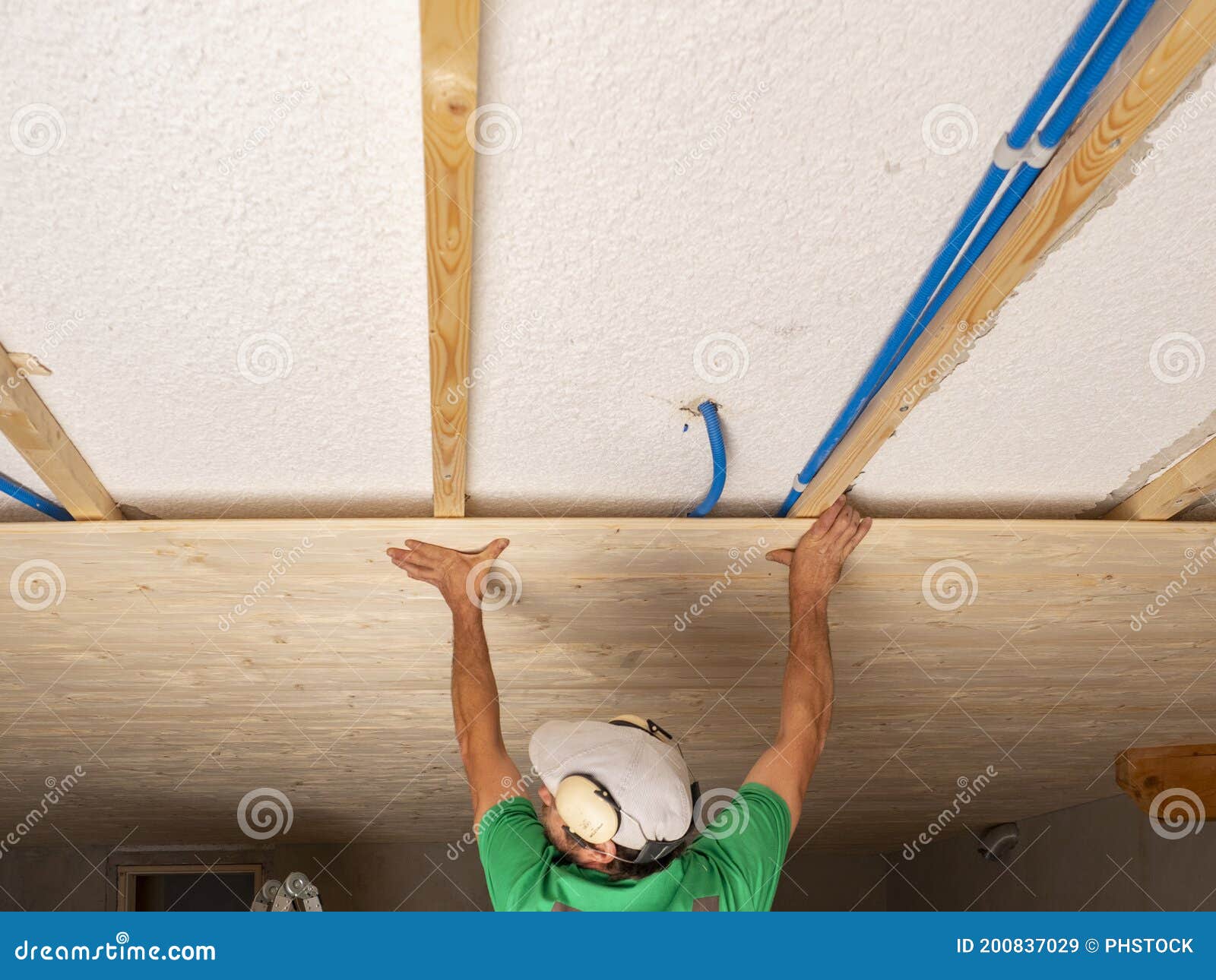 Worker builds ceiling editorial stock image. Image of exterior - 200837029