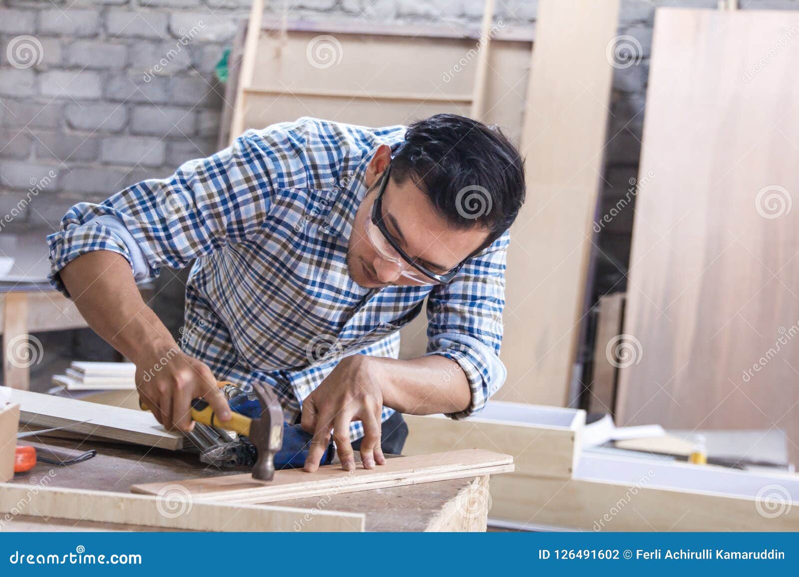 Worker at Carpenter Workspace Installing Nail Using Hammer Stock Photo ...