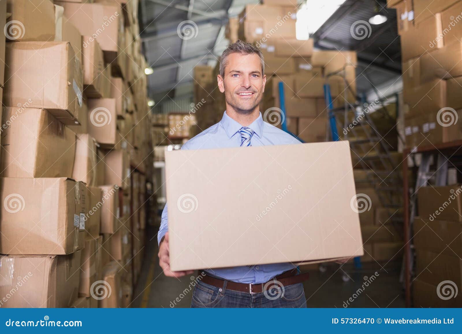 Worker Carrying Box in Warehouse Stock Photo - Image of smiling ...