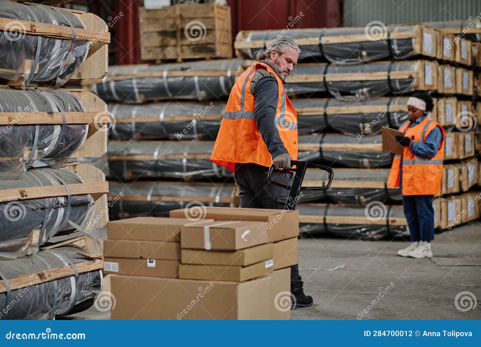 Worker Carrying Containers with Loader Stock Photo - Image of ...