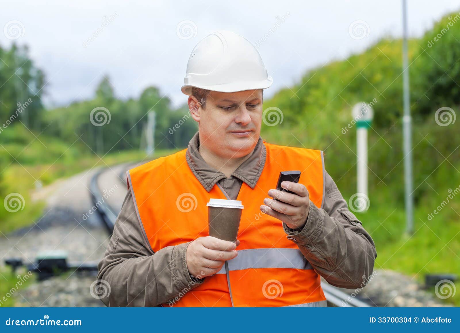 Worker with cell phone stock photo. Image of handle, covered - 33700304