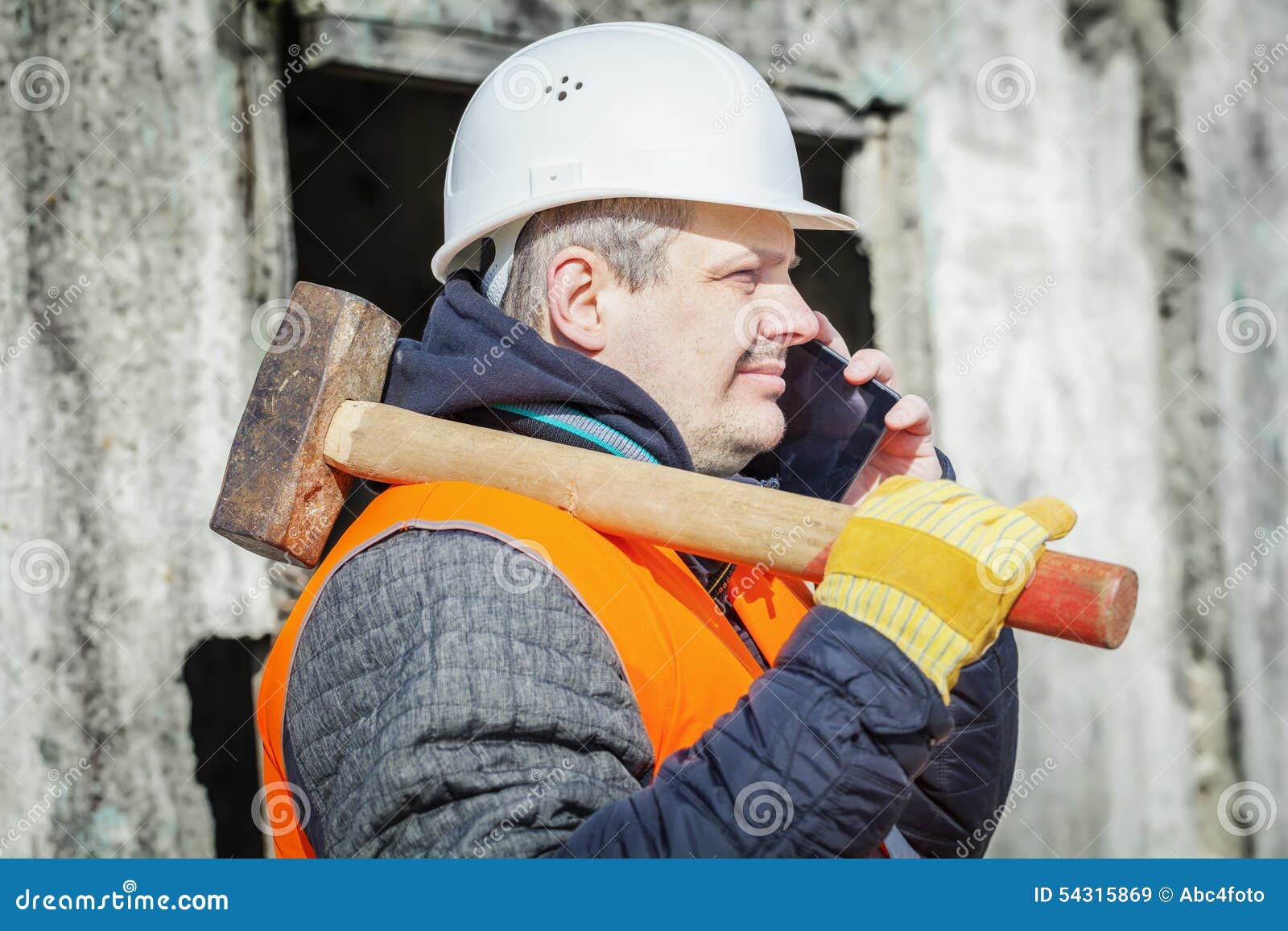 Worker with Cell Phone and Sledge Hammer Near Building Stock Image ...