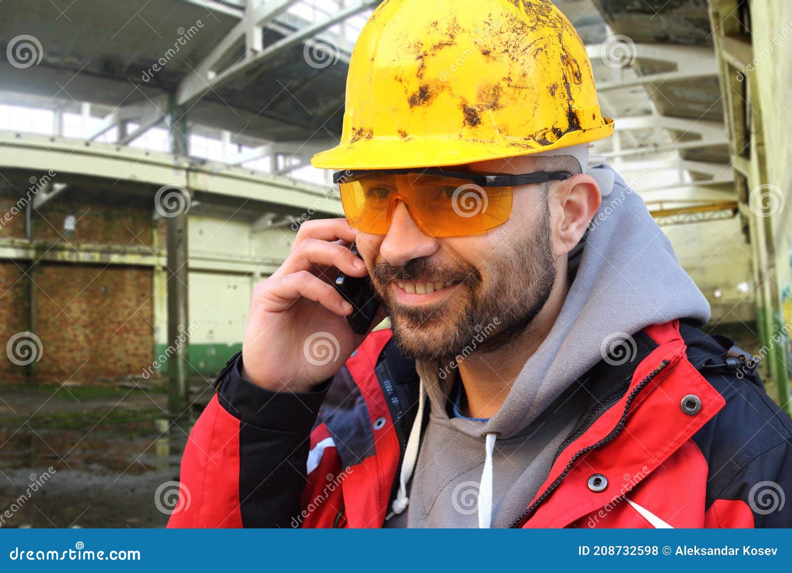 Worker with a cell phone stock photo. Image of hardhat - 208732598
