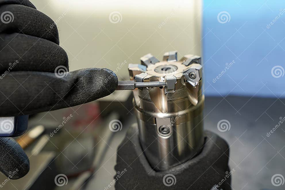 A Worker Changes a High Speed Insert on a Milling Cutter To Work on a ...