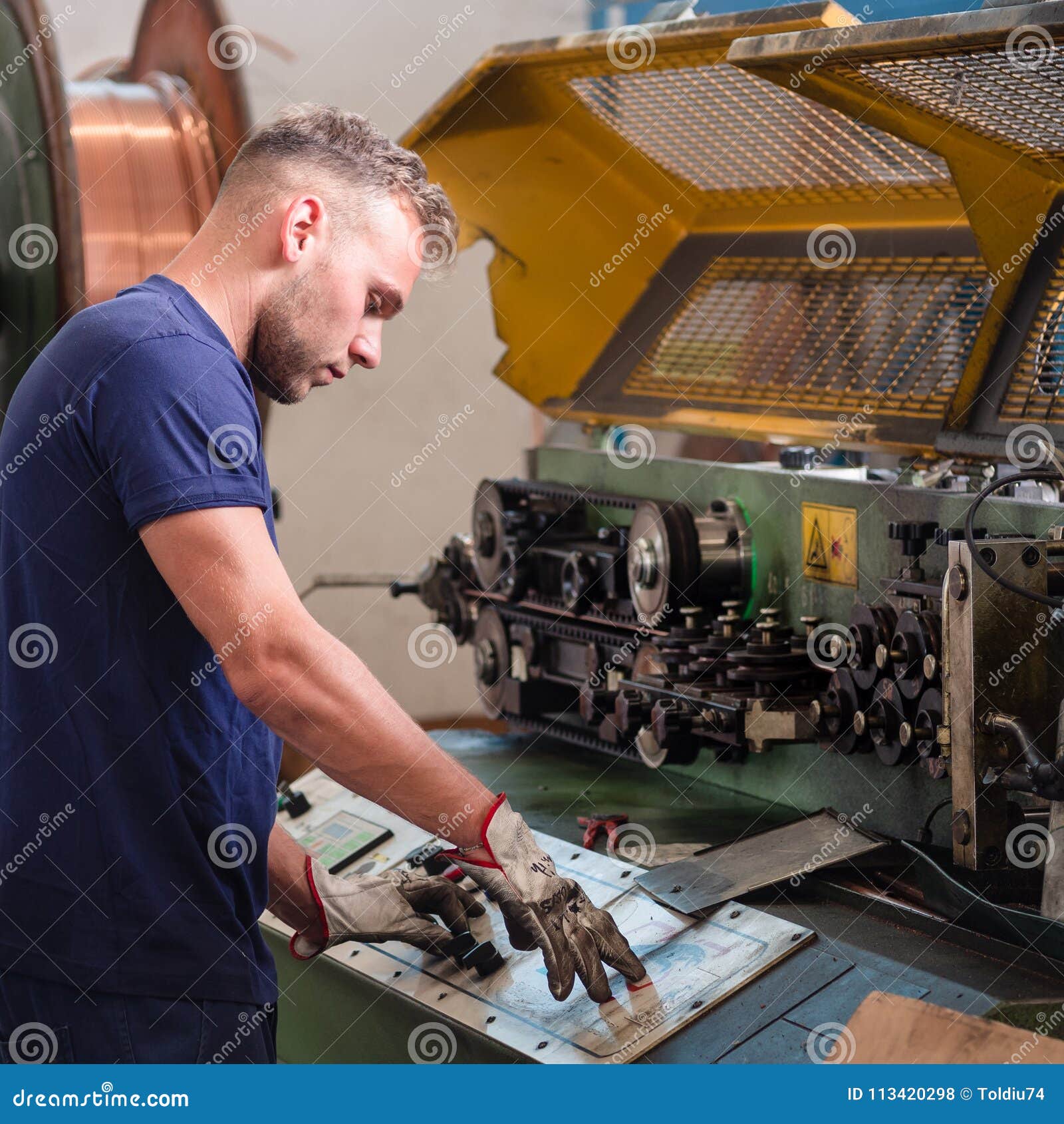 Worker Programs the Straight-cut-bend Machine in a Metalworking ...