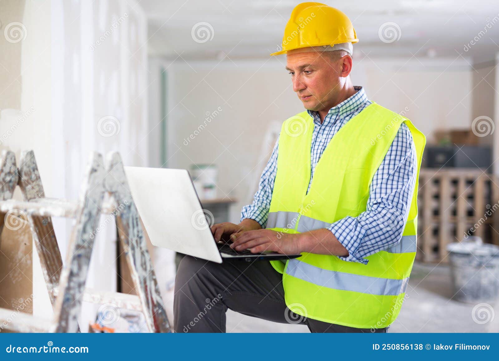 Worker Checking Plan of House Renovation on Laptop Closeup Stock Photo ...