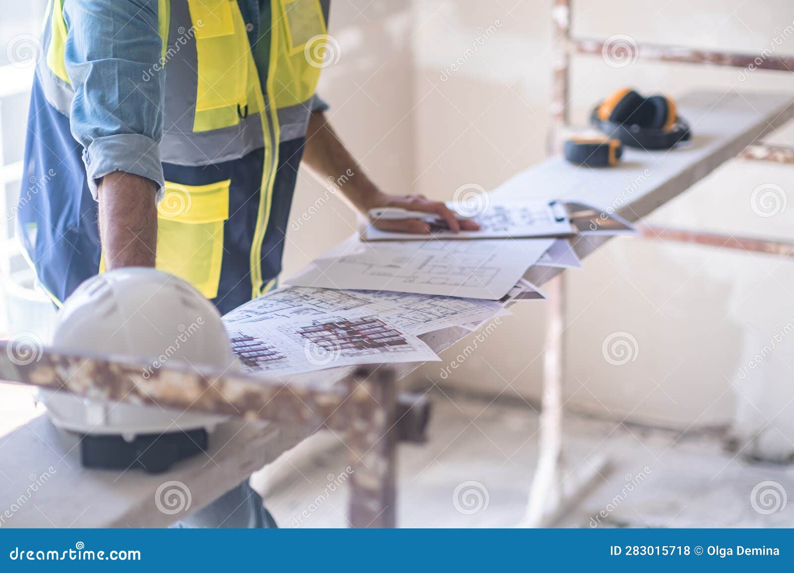 Worker Checking Renovation Project Papers Lying on Construction ...
