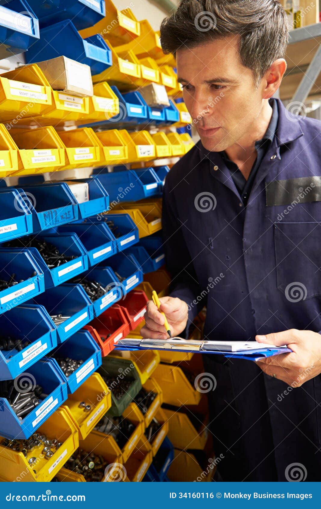 Worker Checking Stock Levels in Store Room Stock Photo - Image of store ...