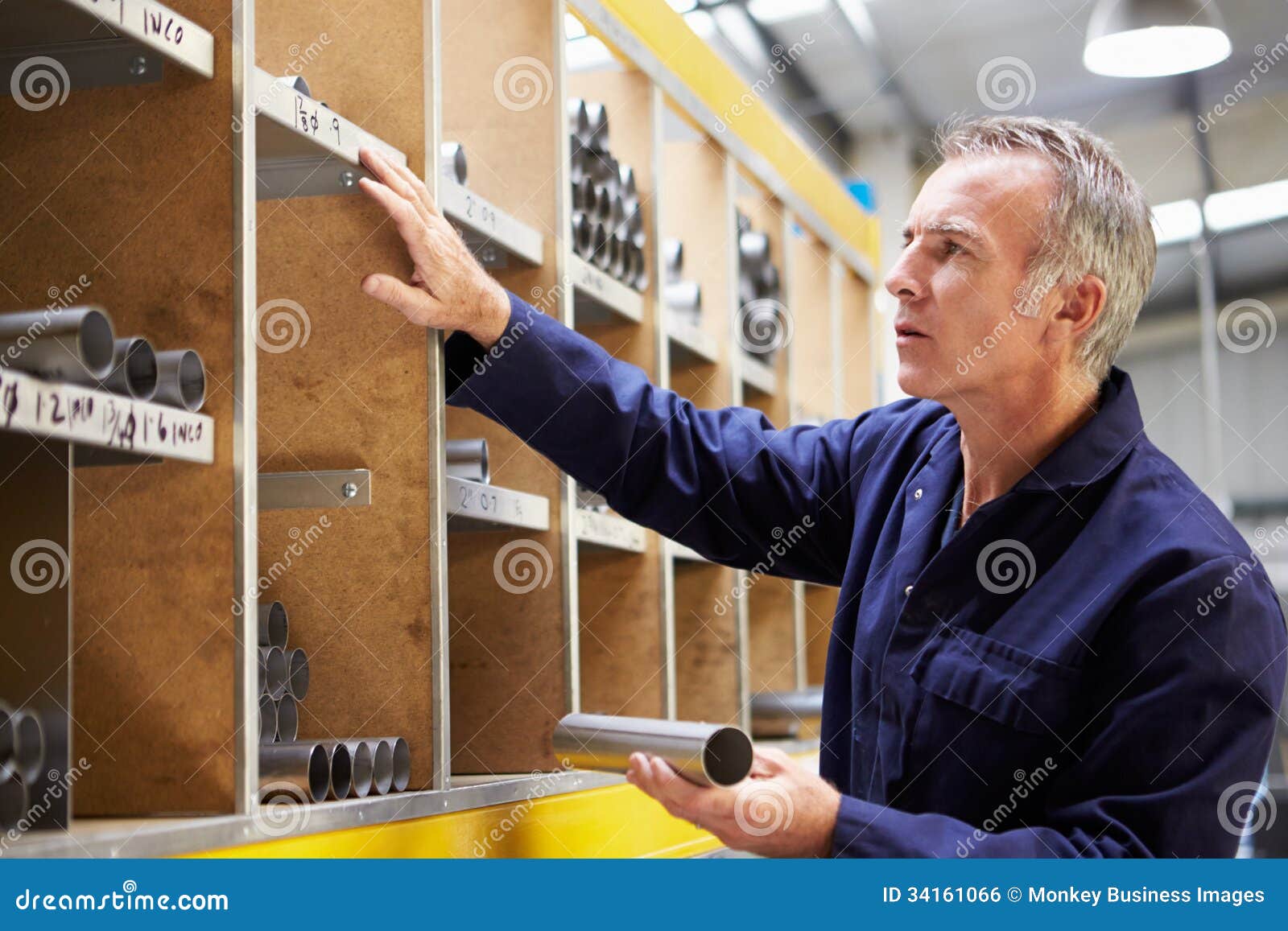 Worker Checking Stock Levels in Store Room Stock Photo - Image of ...