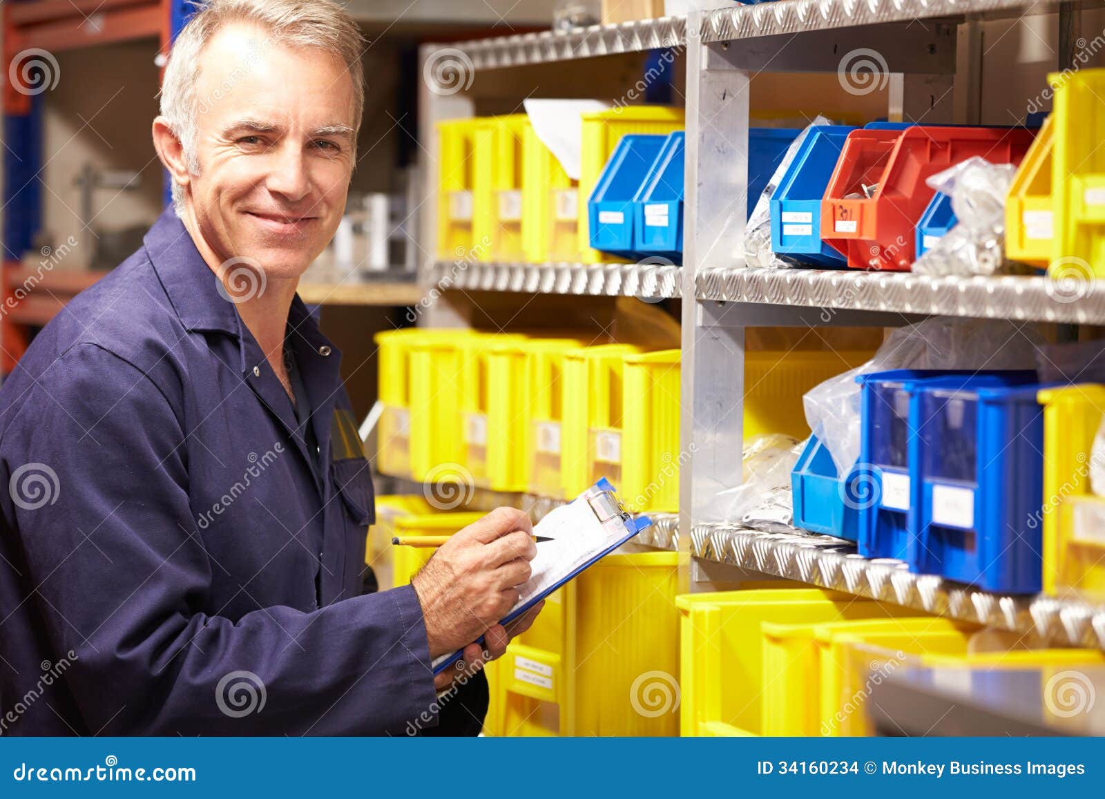 Worker Checking Stock Levels in Store Room Stock Photo - Image of ...